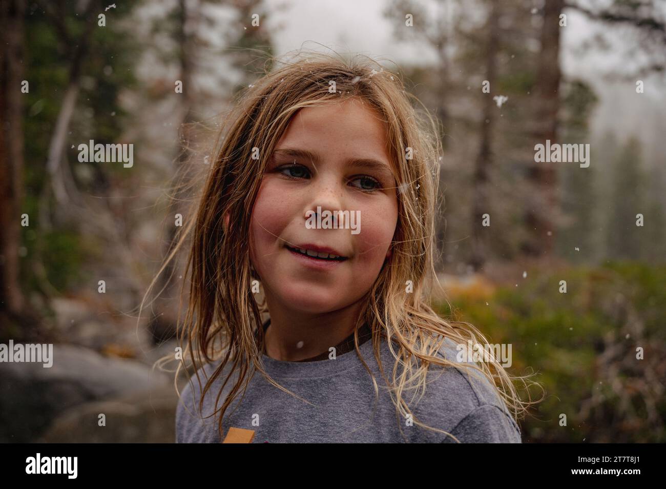 Portrait of tween outside in the snowfall with snow in hair Stock Photo ...
