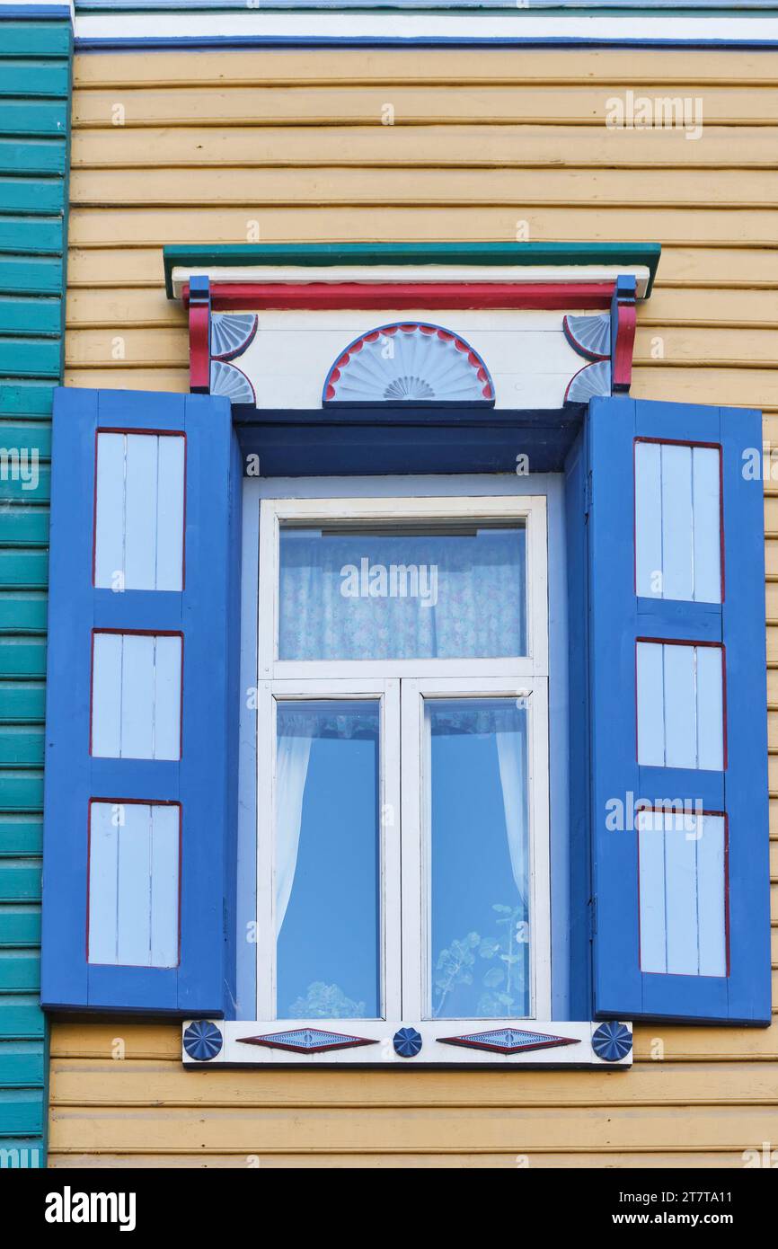 Traditional window with carved wooden colorful architraves and exterior ...