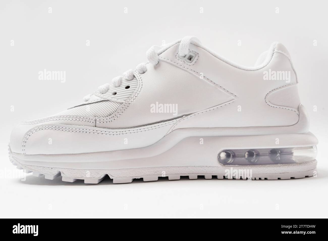 Leather trainers with a shadow on white background Stock Photo - Alamy
