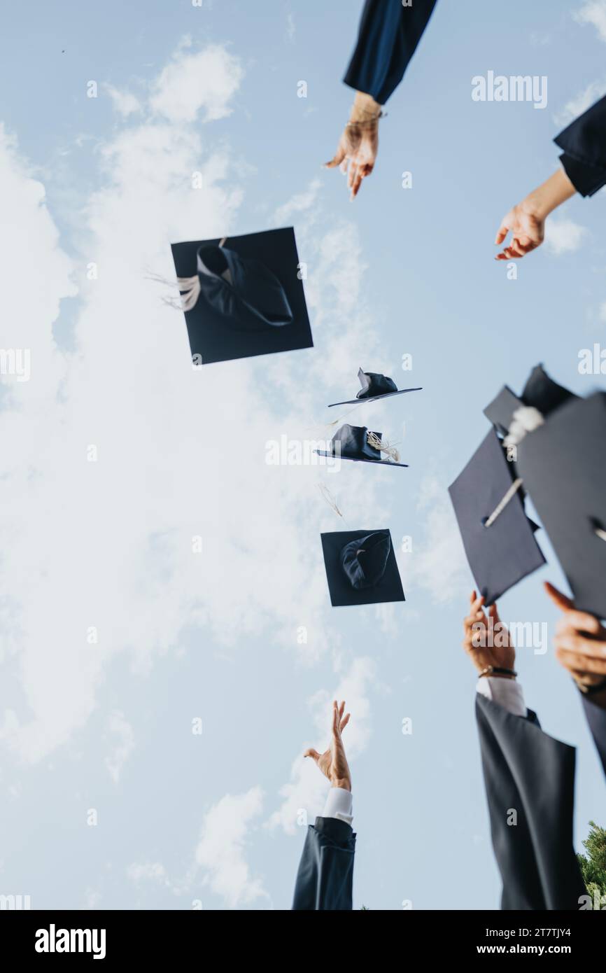 Students throwing their caps in the air, enjoying their university ...