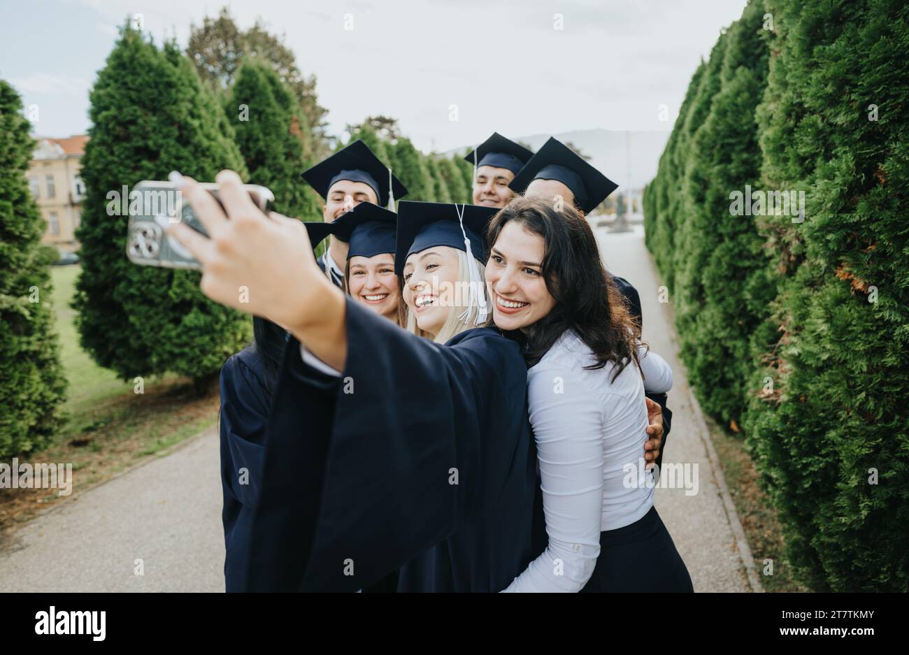 Students Celebrating Graduation Outdoors with Faculty Colleagues Stock ...