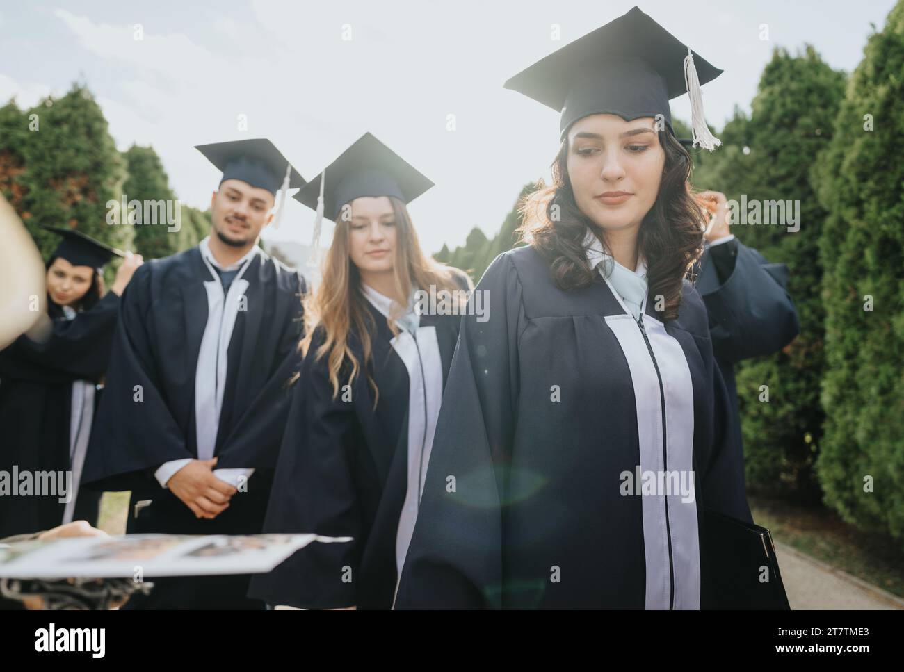 Graduates Celebrating Achievements in Park - Students in Gowns and Caps ...
