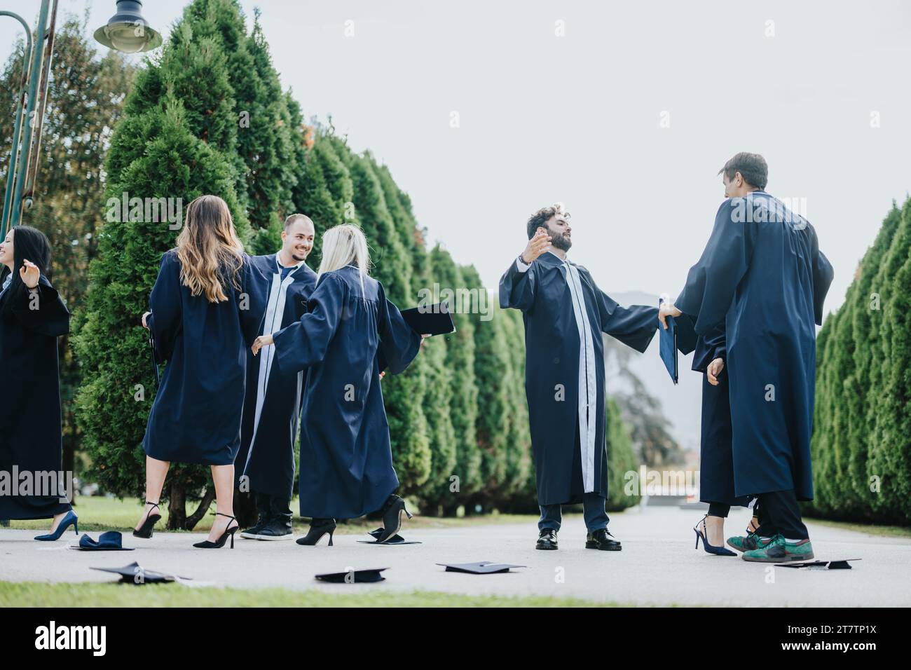 University students in graduation uniform celebrating achievements ...