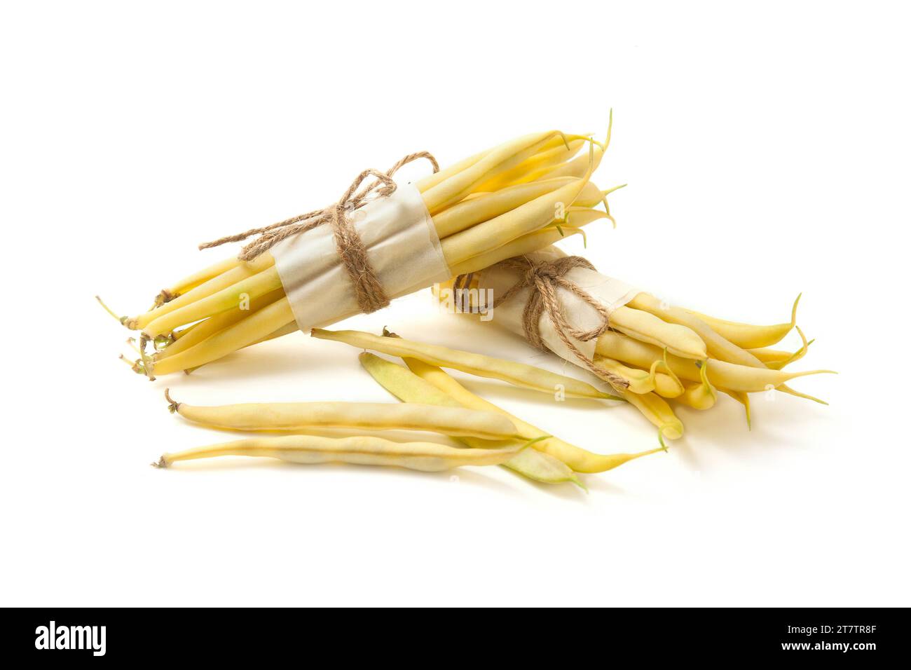 Two bunches and small pile of raw yellow pods of haricot isolated on ...