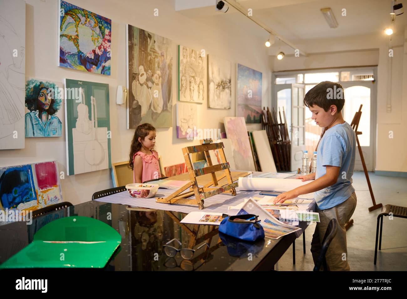 Adorable diverse kids learning painting and drawing at fine art class ...