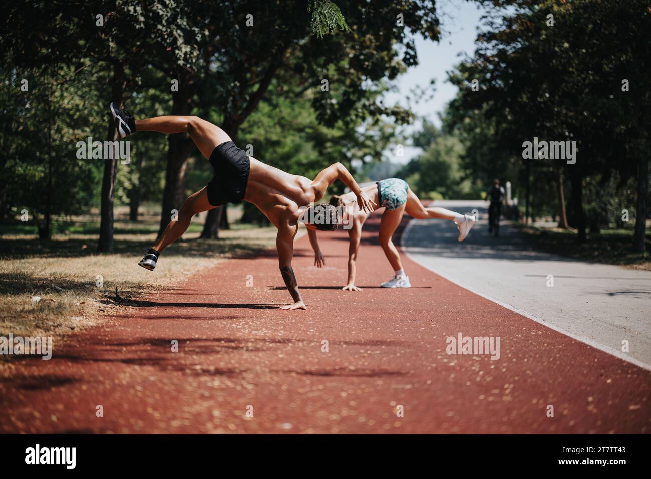 Active Athletes Practicing Cartwheel in a Sunny Park Together Stock ...