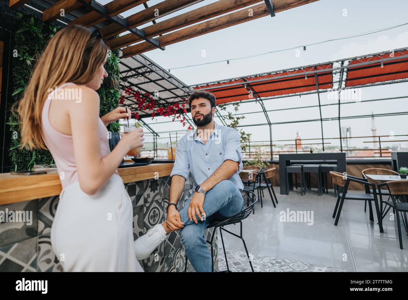 Young executives discussing business ideas at an urban cafe, planning ...