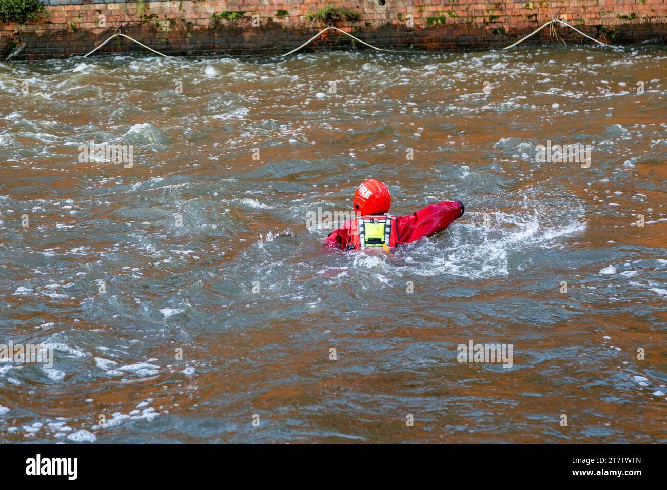 Fireman swimming across swollen River Kennet in training exercise ...