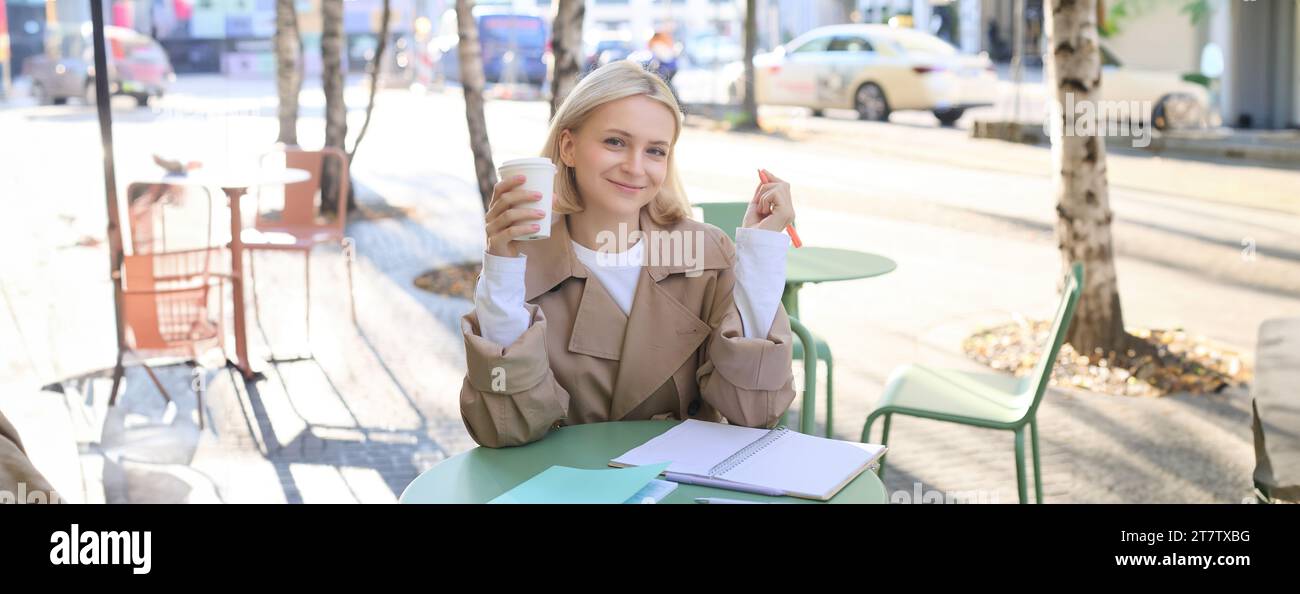 Image of beautiful young blond woman, girl drinking coffee in outdoor ...