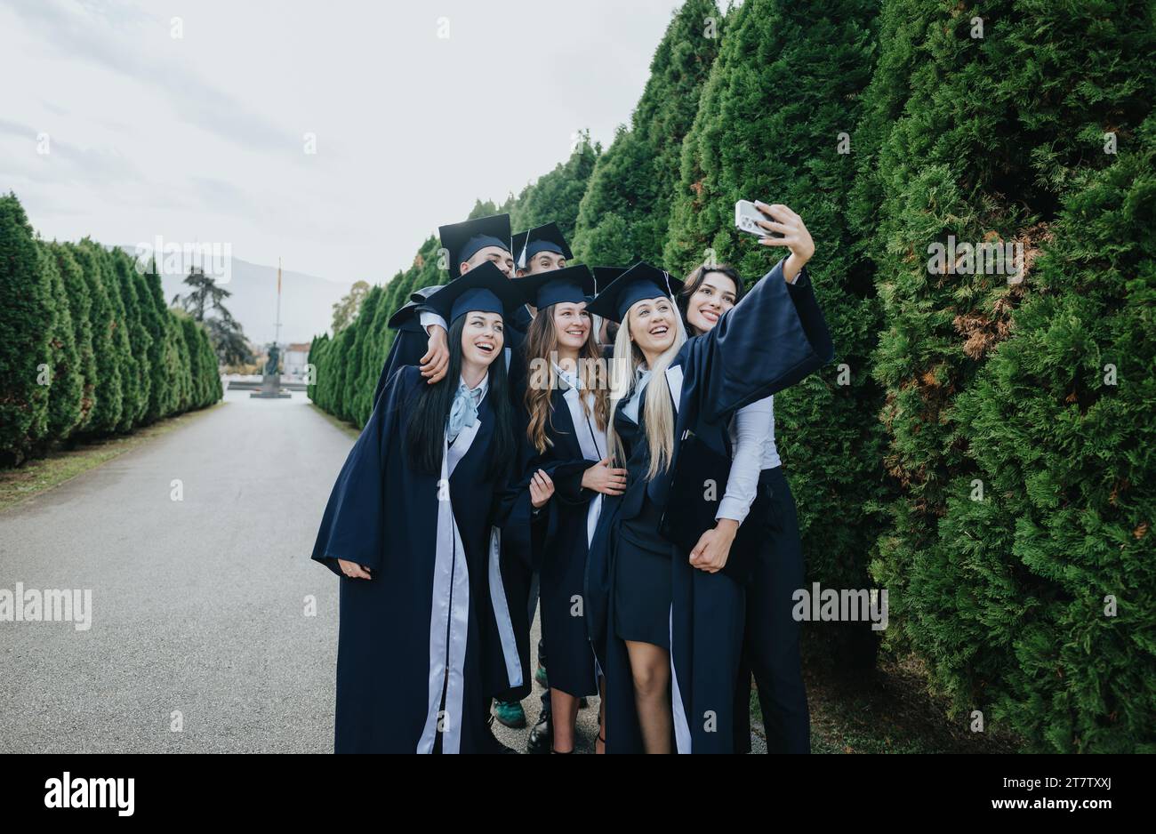 University Graduates Celebrating Achievements in Park with Faculty ...