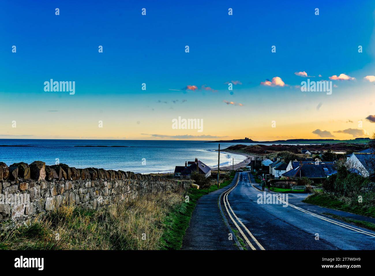 A curving road leads down to the village of Low Newton, Northumberland ...