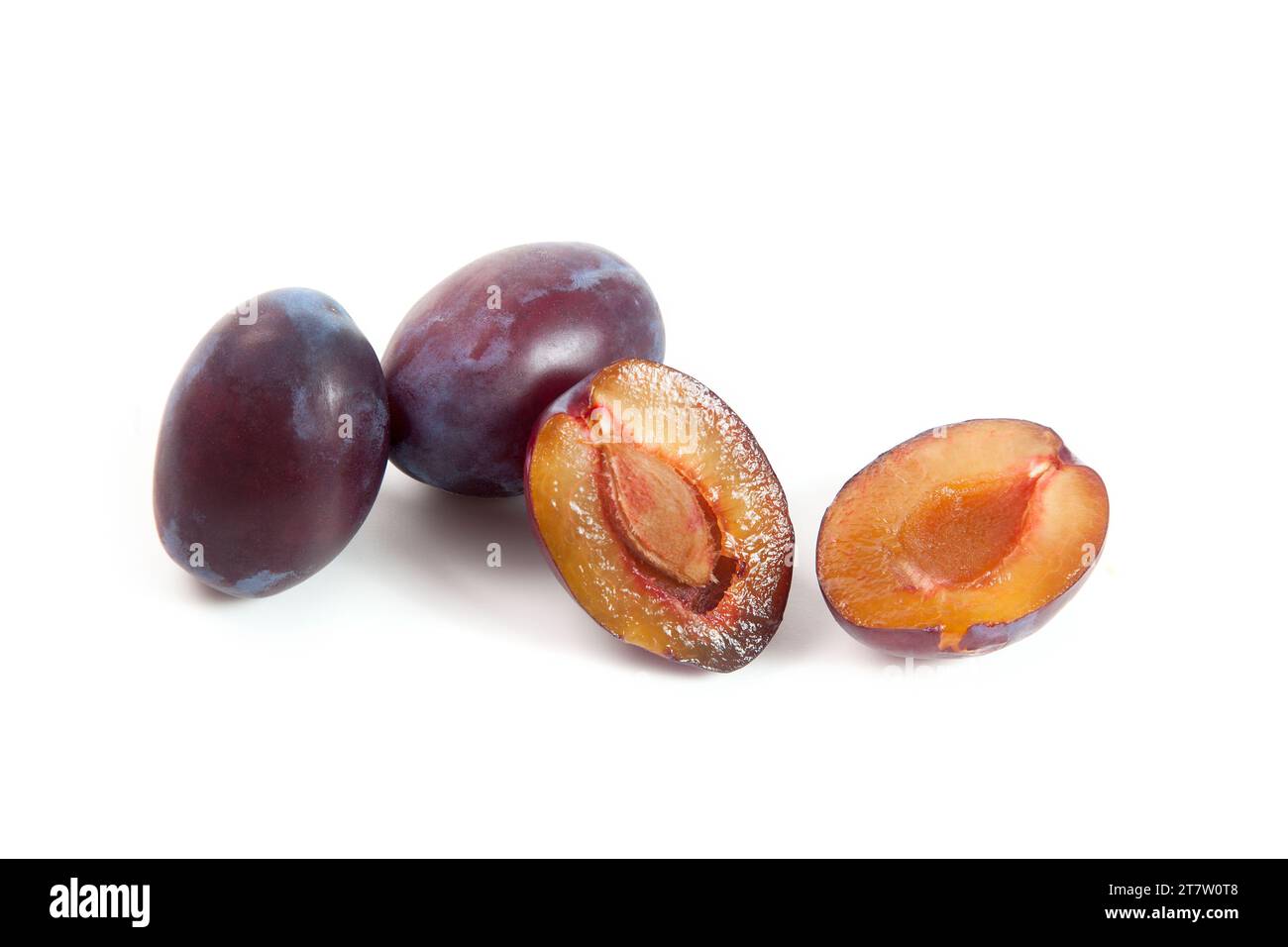 Juicy summer plum fruit. Two whole fruit and Halves ripe sweet plums ...
