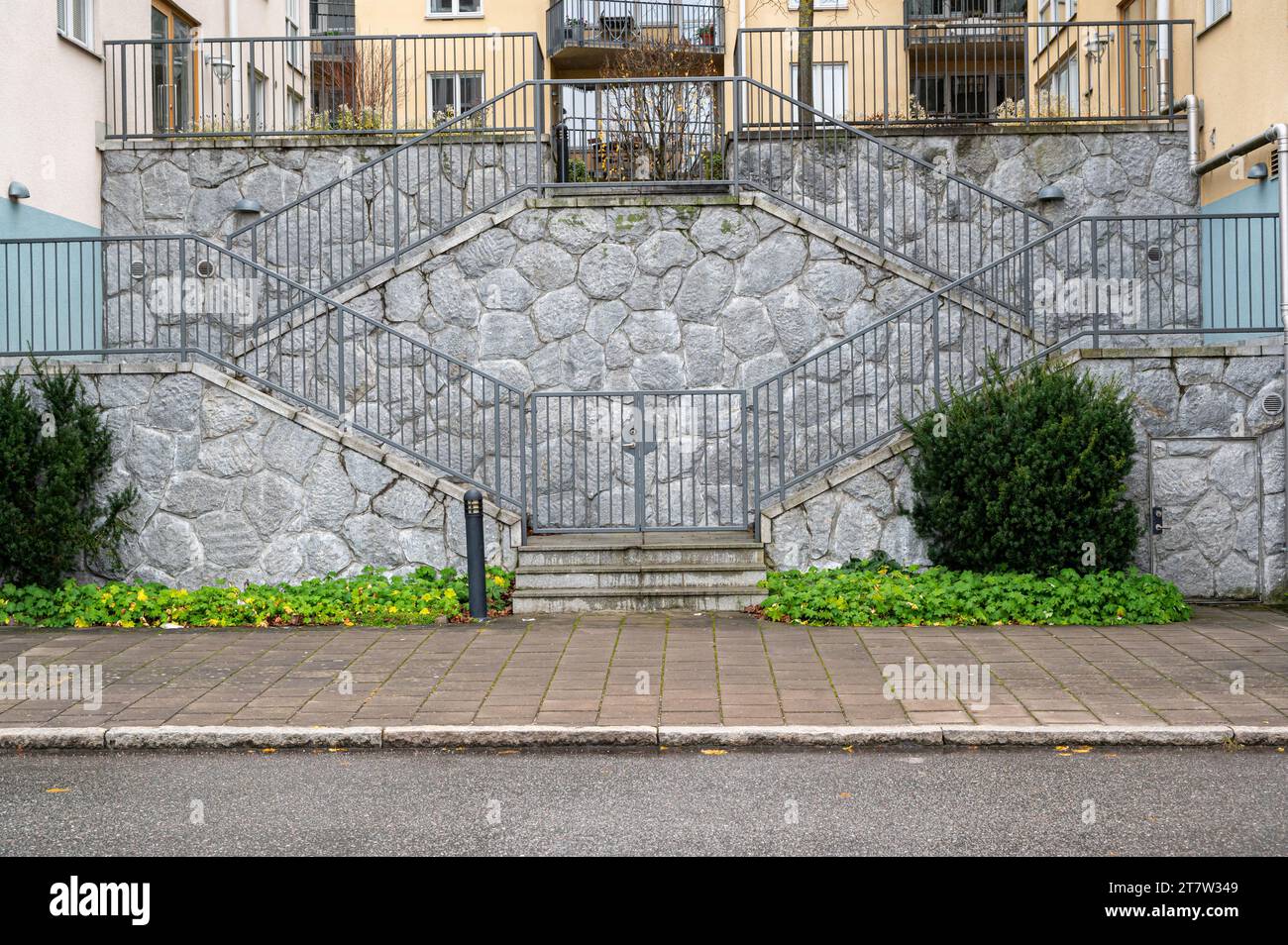 Stairs outside with metal railing and metal gate Stock Photo - Alamy
