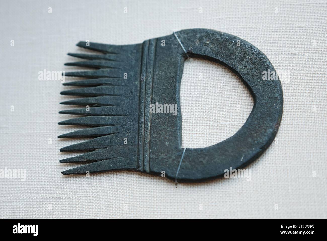 An ancient bronze comb with long, evenly spaced teeth, used for ...