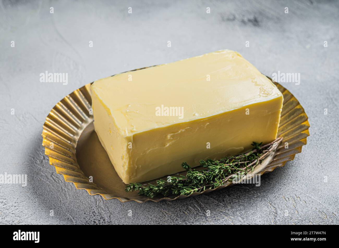 Butter block on steel plate. White background. Top view Stock Photo - Alamy