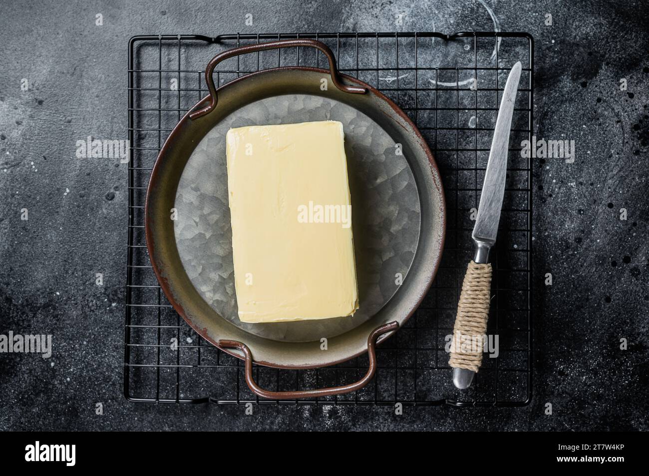 Butter block in steel kitchen tray. Black background. Top view Stock ...
