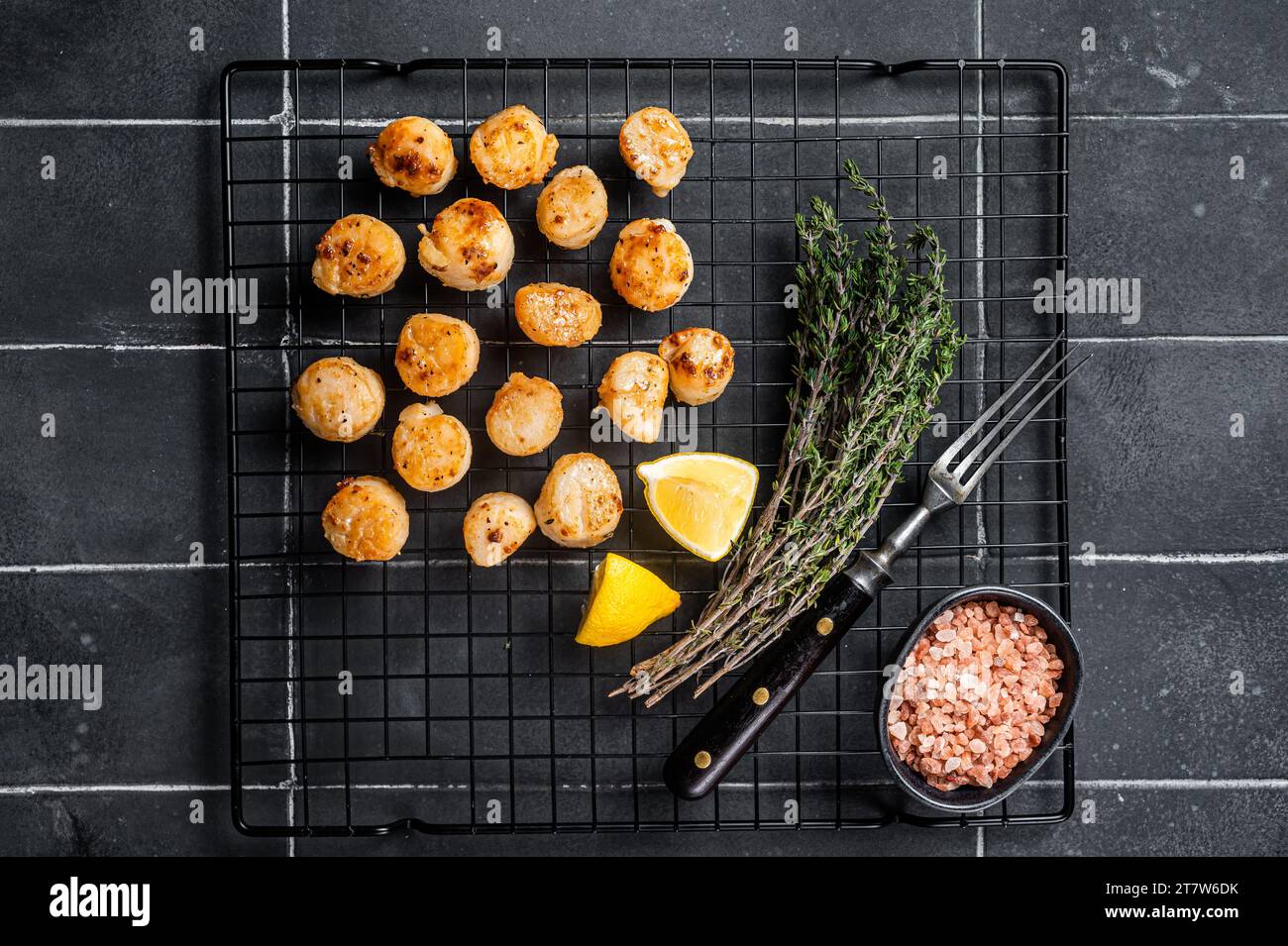 Grilled Scallops fillets on a rack. Black background. Top view Stock ...