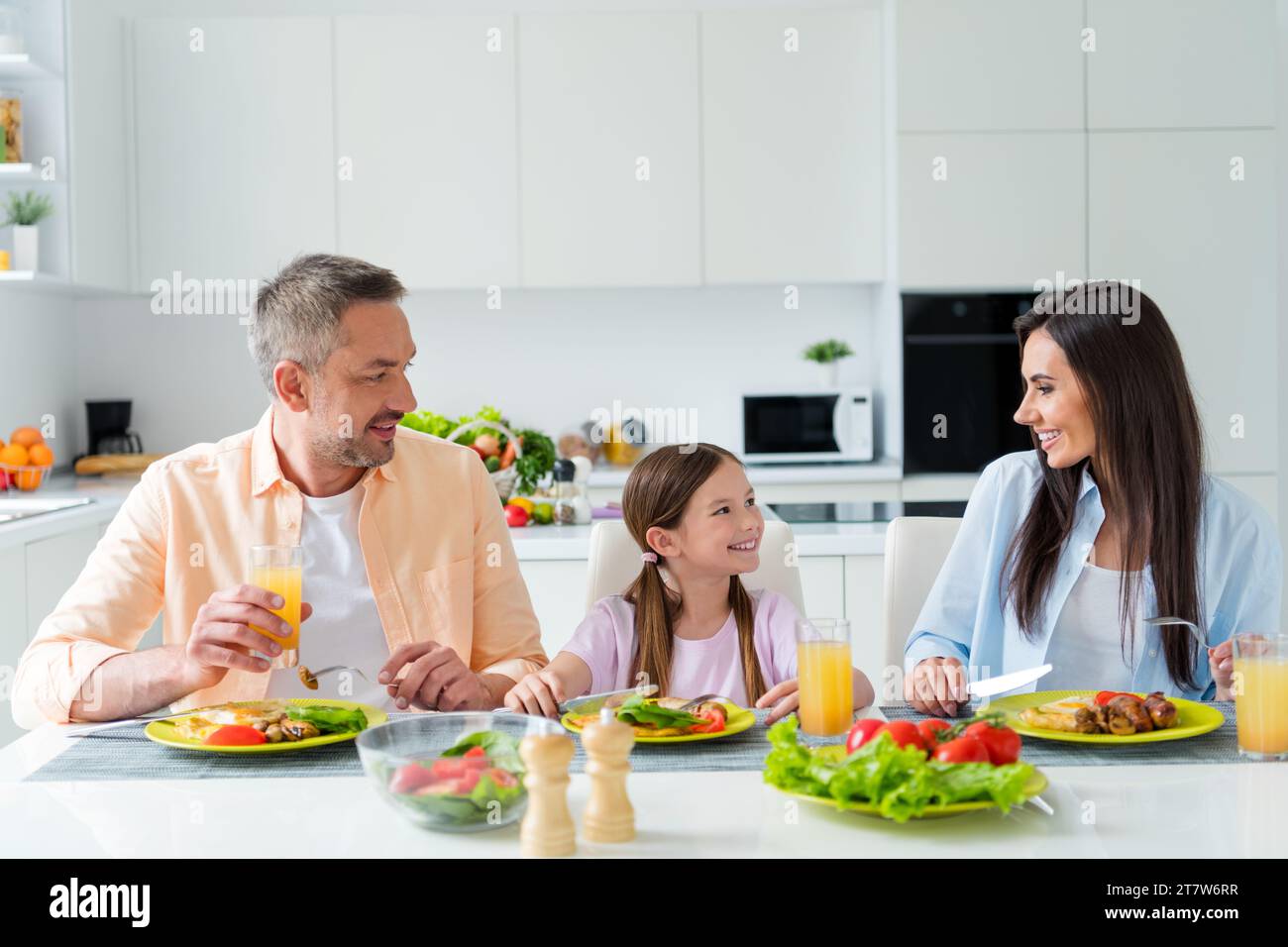 Photo of positive good mood wife husband little girl eating tasty meal ...
