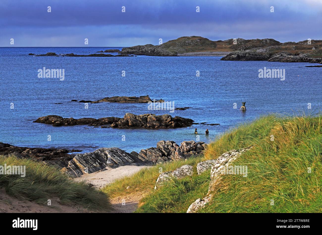 A view of Bosta Beach at high water with two swimmers and the Tide and ...