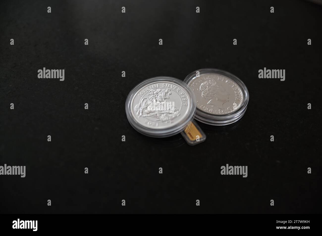 Two Silver Coins and a Gold Piece Stock Photo - Alamy