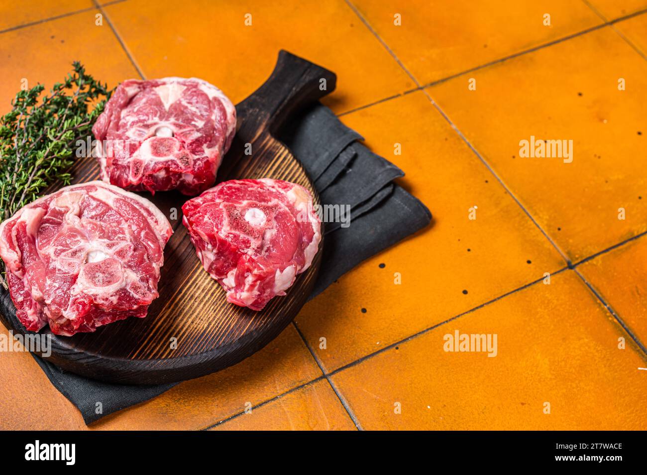 Raw lamb neck chops, fresh mutton meat on a butcher board with herbs ...