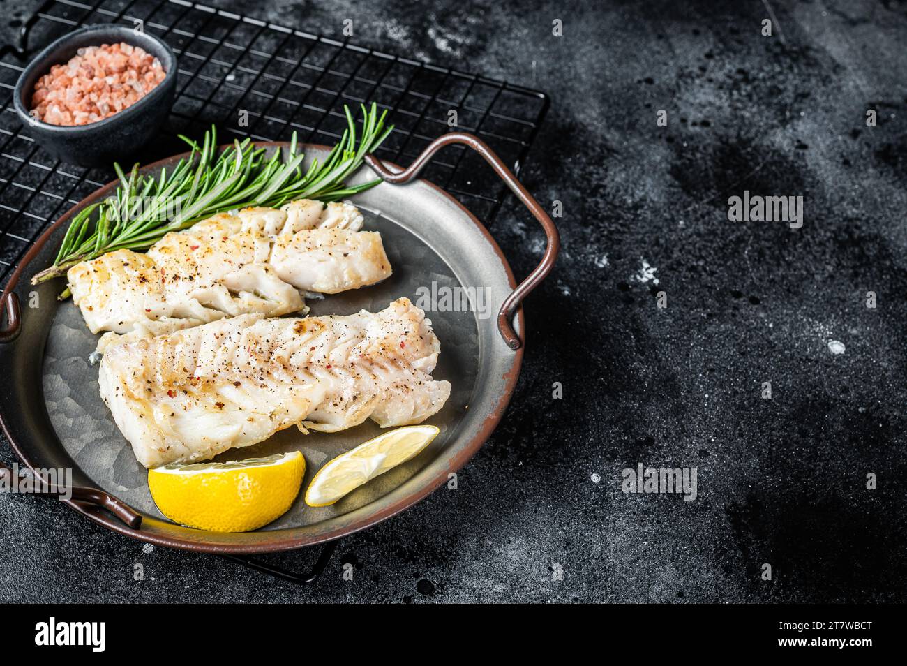 Roast Fillets of codfish, cooked cod fish meat. Black background. Top ...