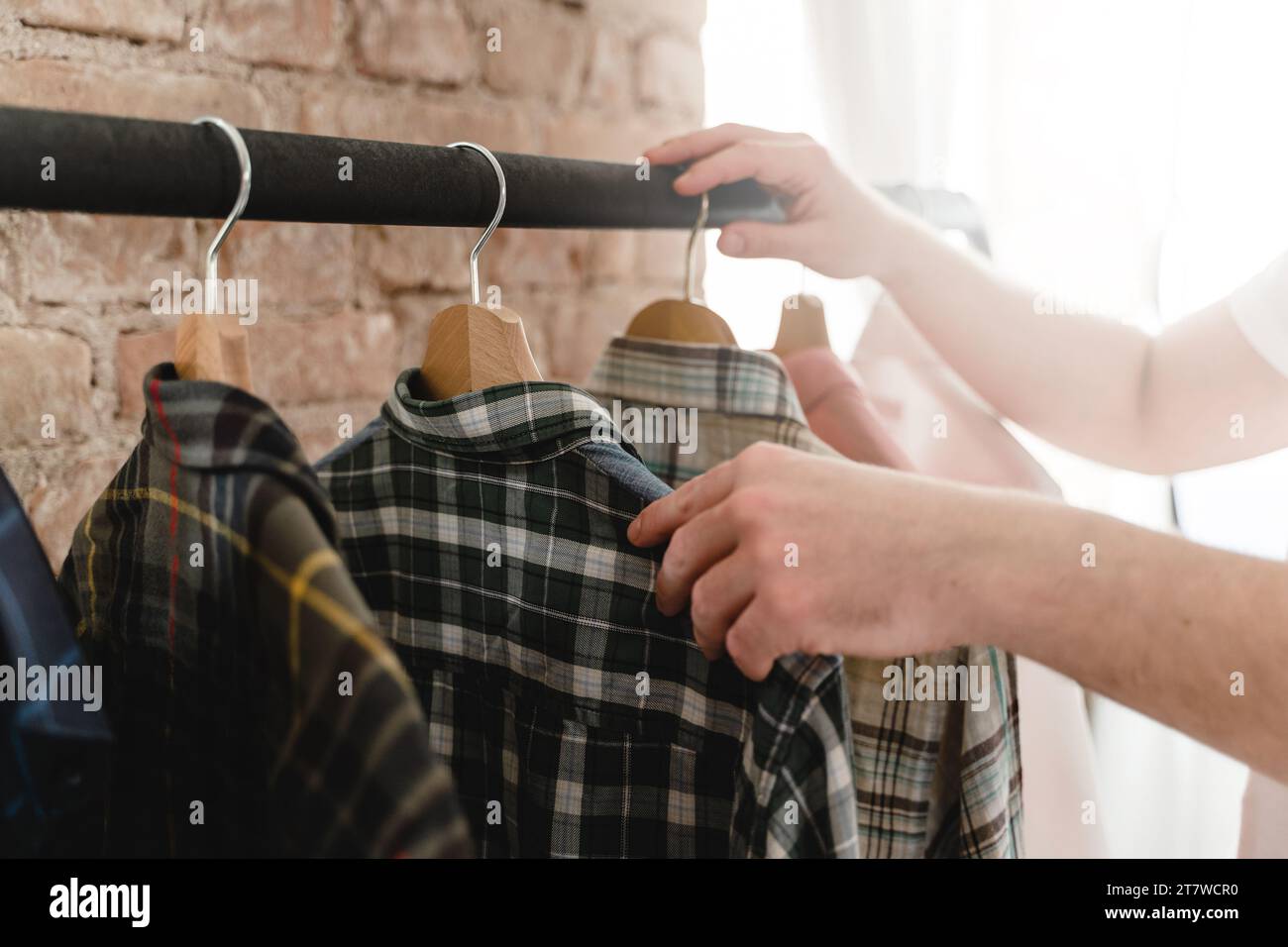 Man browsing shirt in clothing store hi-res stock photography and ...