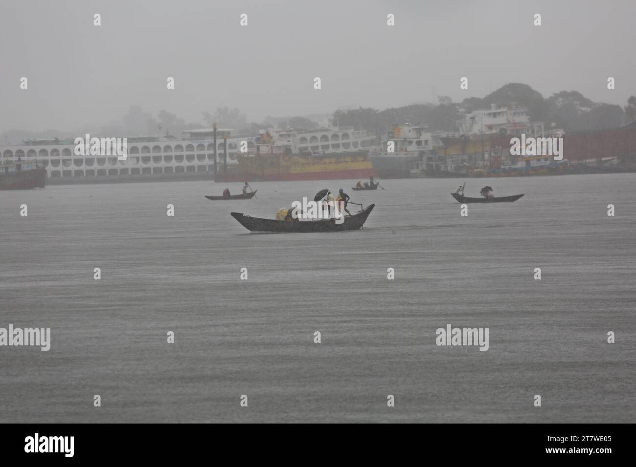Bangladeshi passengers cross the Buriganga River during the heavy rain ...