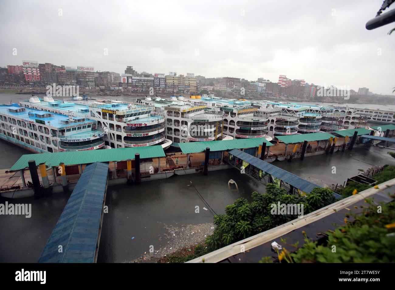 Bangladeshi passengers cross the Buriganga River during the heavy rain ...