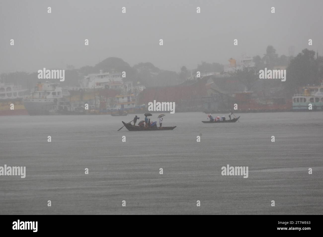 Bangladeshi passengers cross the Buriganga River during the heavy rain ...