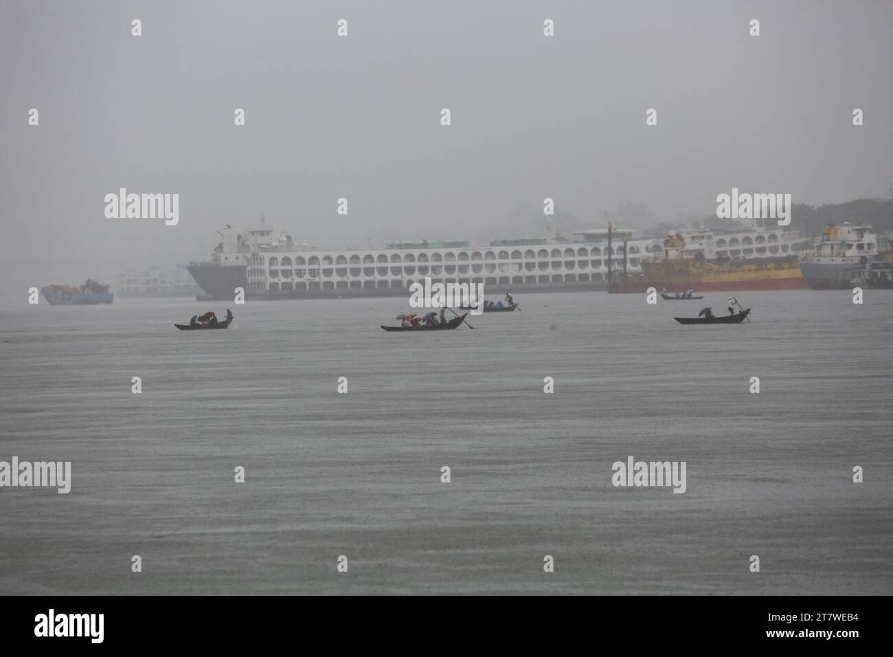 Bangladeshi passengers cross the Buriganga River during the heavy rain ...