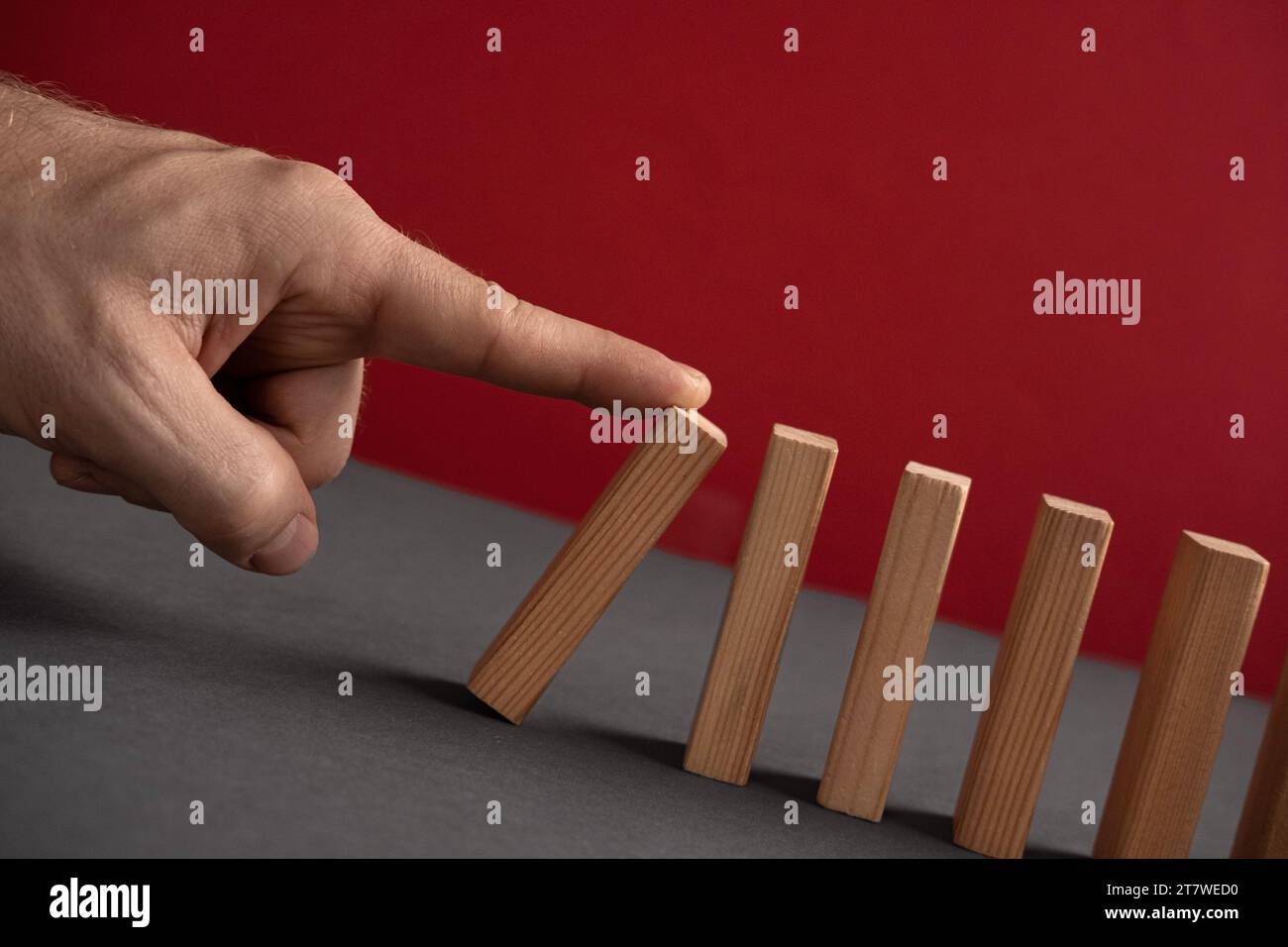 Domino has Fallen in a Row. Domino theory. Effect. Hand with Finger is ...