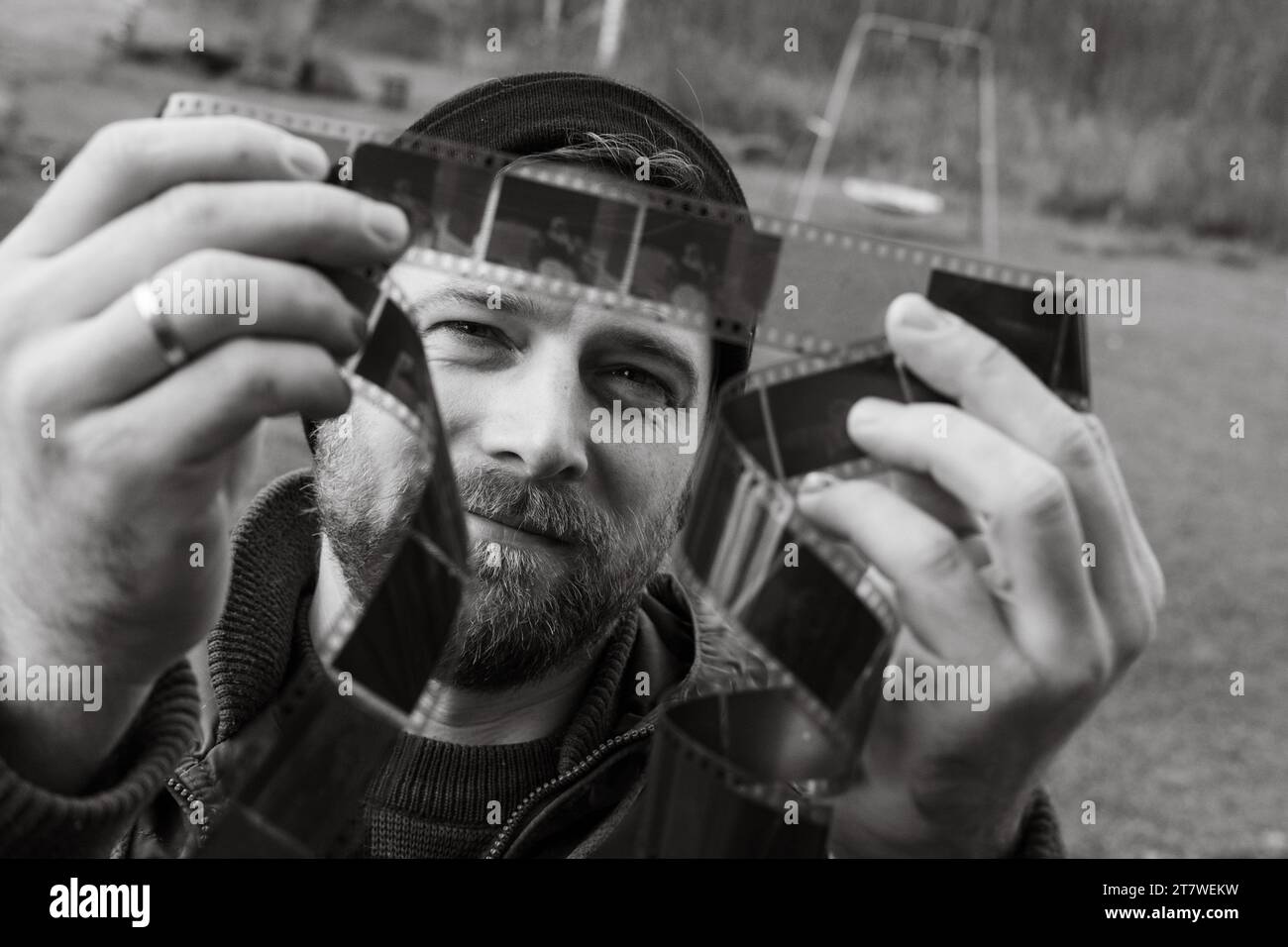 Man looks with interest at a vintage photographic film. Concept of ...