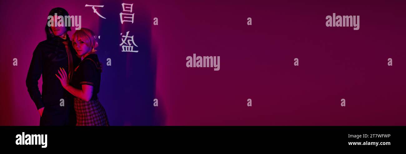 cosplay students in uniform in neon light on purple backdrop with ...