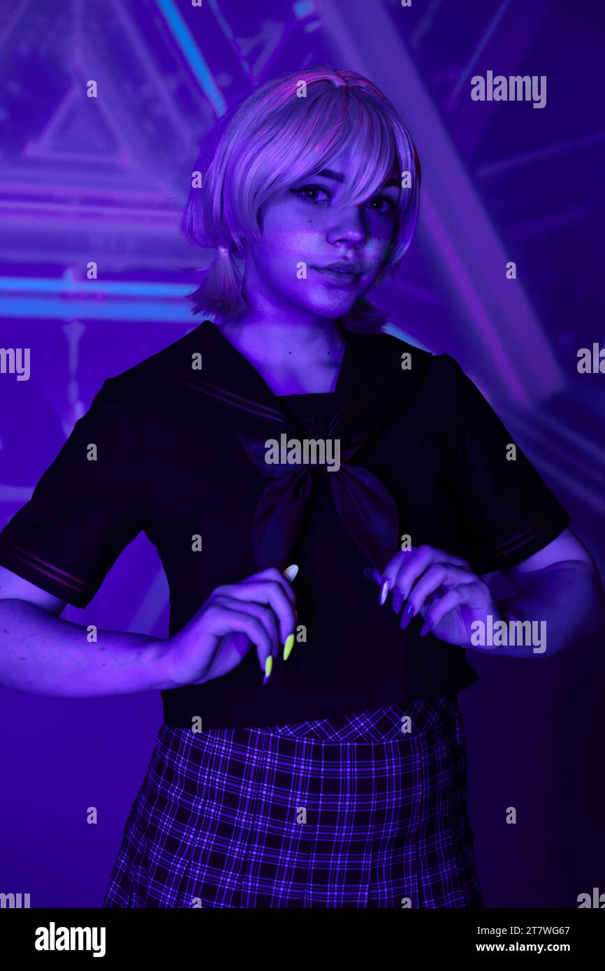 youth cosplay culture, woman in blonde wig and school uniform looking ...