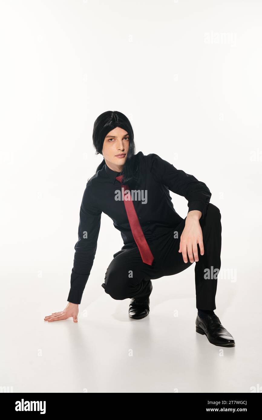 anime man in black clothes and wig with red tie sitting on haunches ...