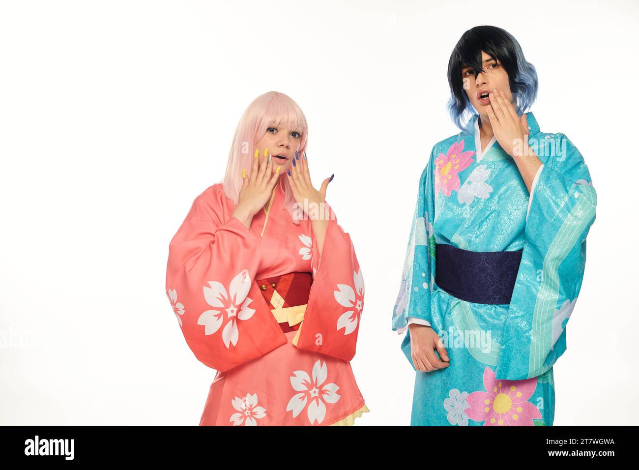 astonished anime couple in colorful kimonos and wigs touching faces on ...