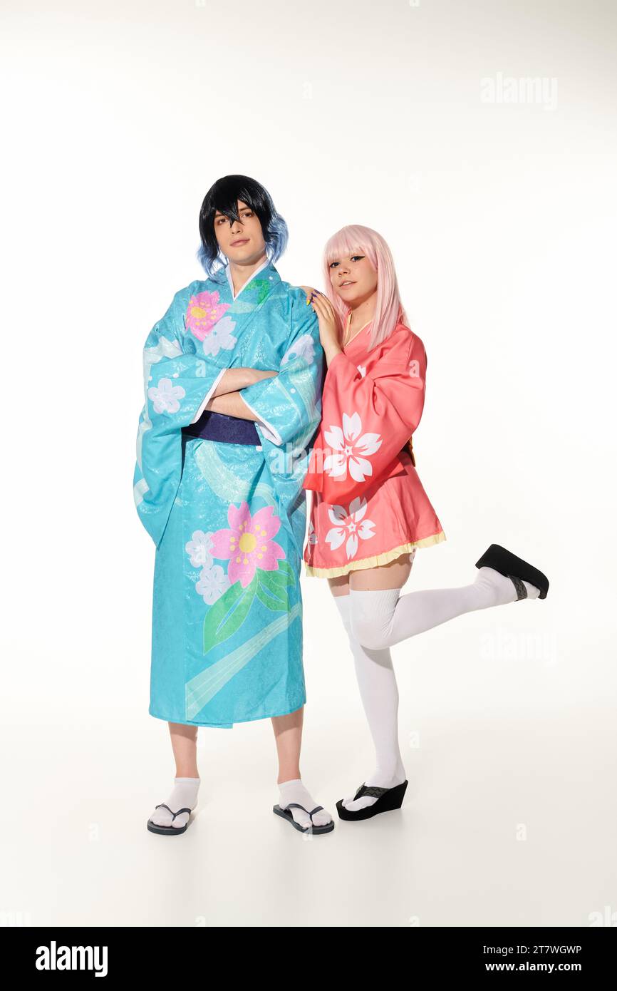 woman leaning on boyfriend in colorful kimono and wig standing with ...