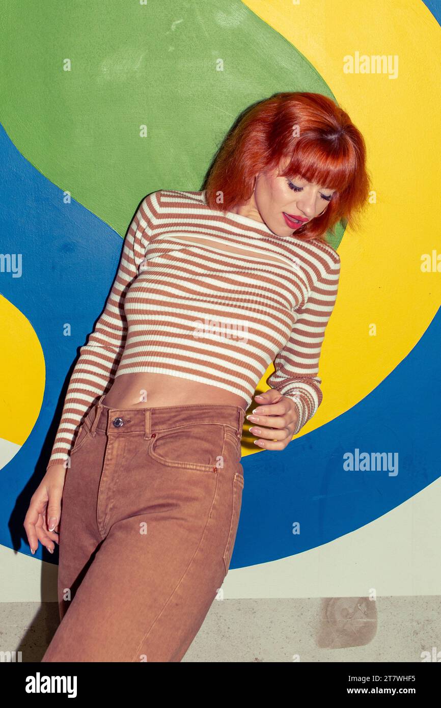 Young stylish redhead Caucasian woman in retro style of 70s posing at ...