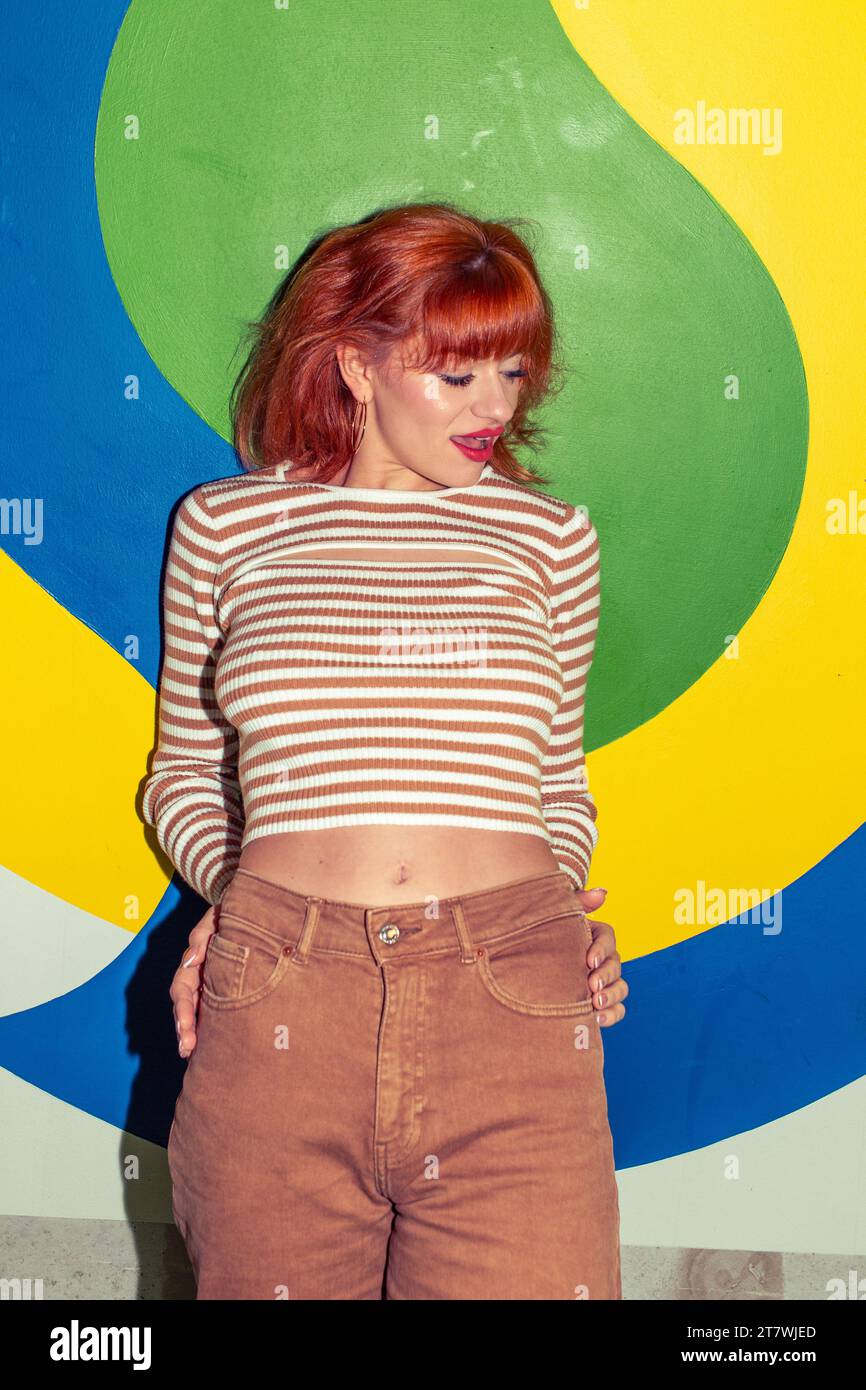 Young stylish redhead Caucasian woman in retro style of 70s posing at ...