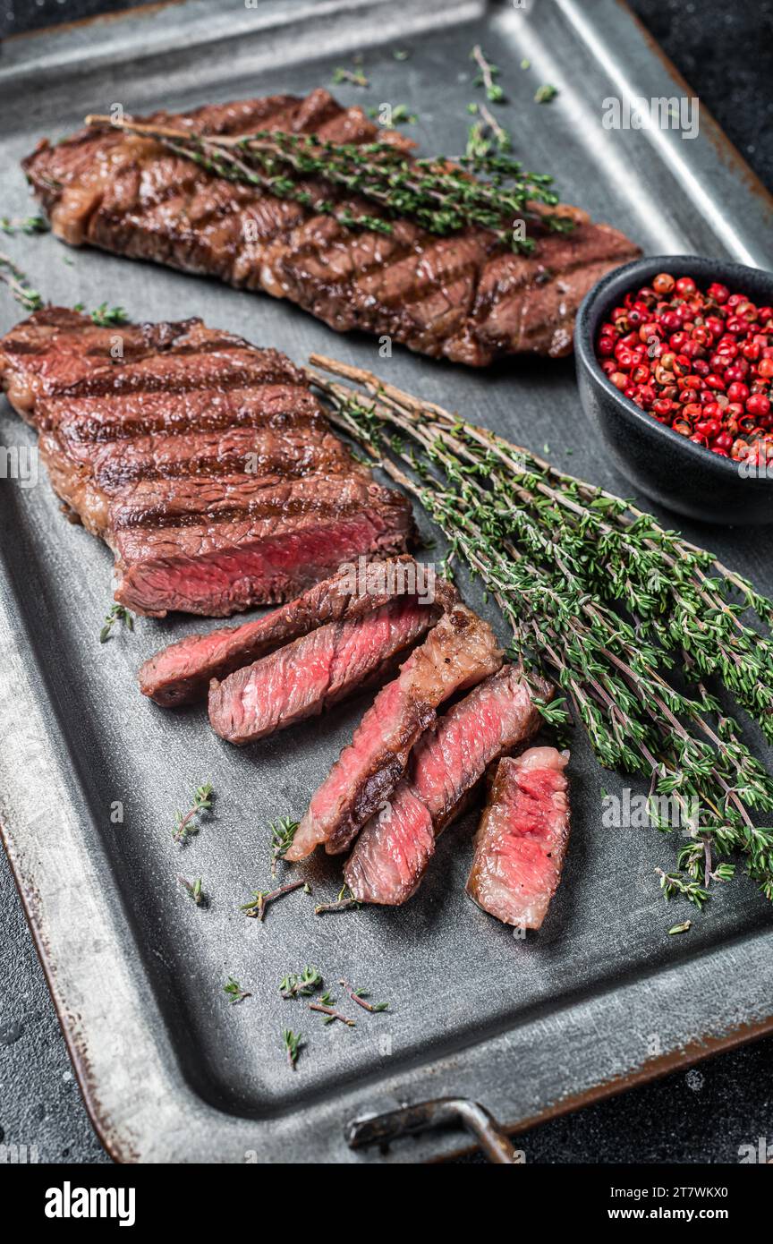 BBQ roast denver top blade beef meat steak on a steel tray with herbs ...