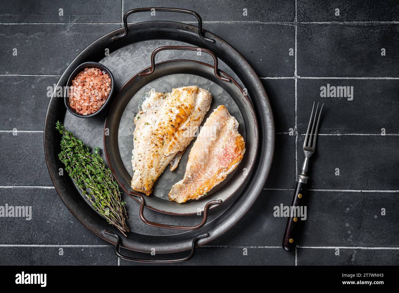 Roasted ocean red perch fillet with olive oil, thyme and spices. Black ...