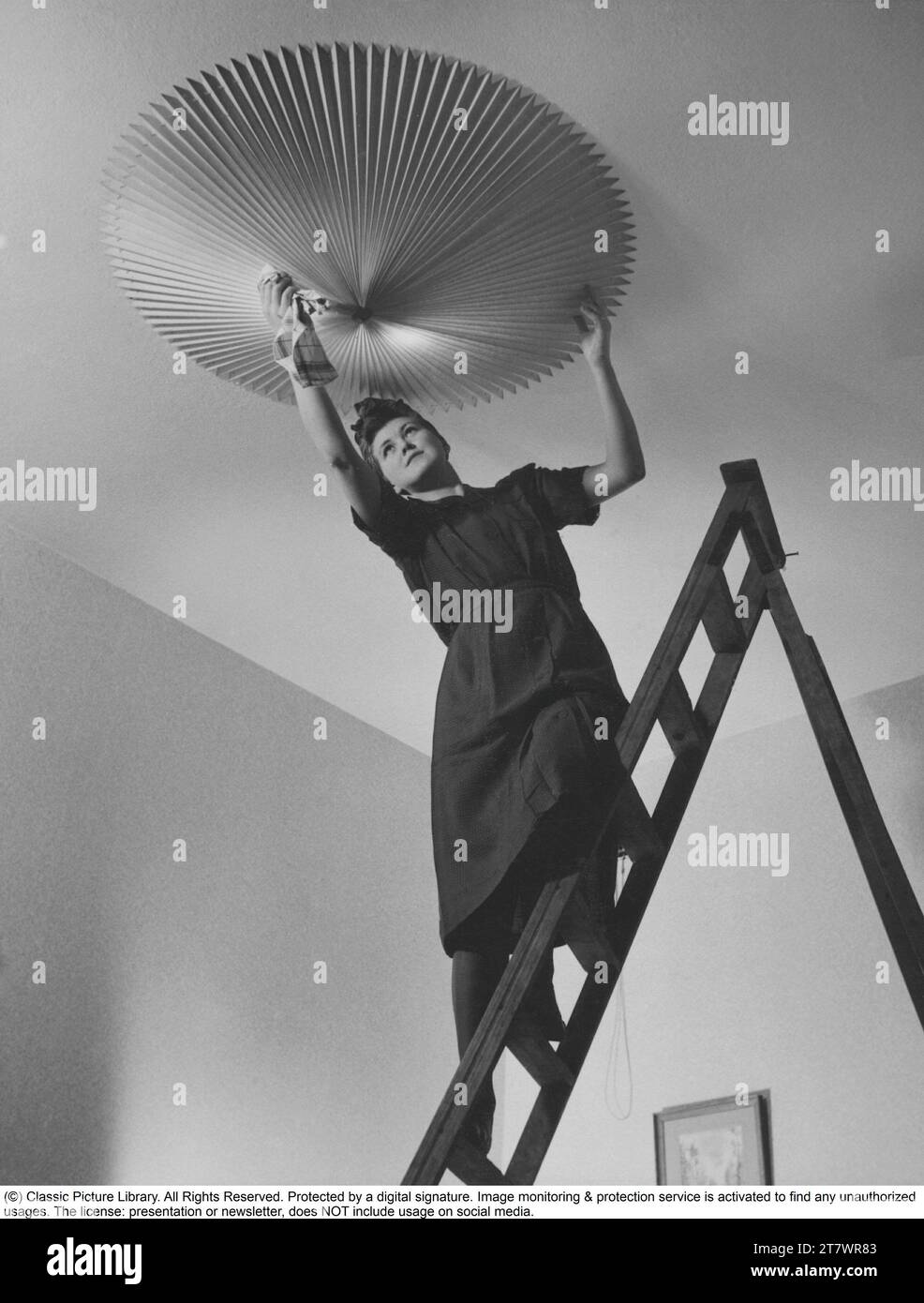 Woman dusting lights hi-res stock photography and images - Alamy