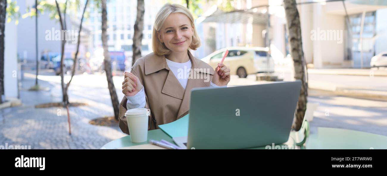 Remote workplace. Smiling young woman freelancer, student using laptop ...
