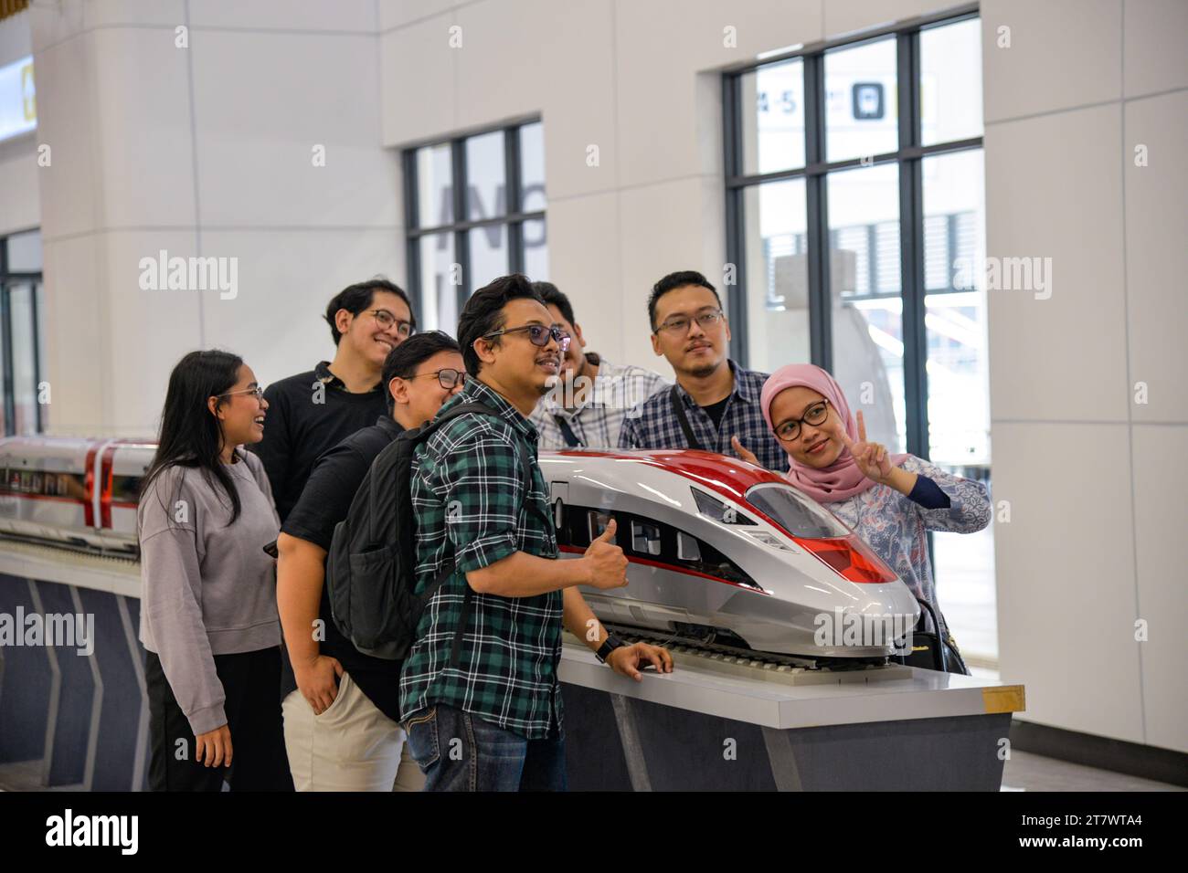 Jakarta, Indonesia. 17th Nov, 2023. Passengers pose for photos with a model of a high-speed ...