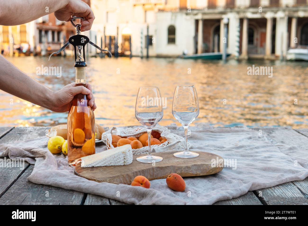 Rose wine, fruits and snacks on the wooden pier during picturesque ...
