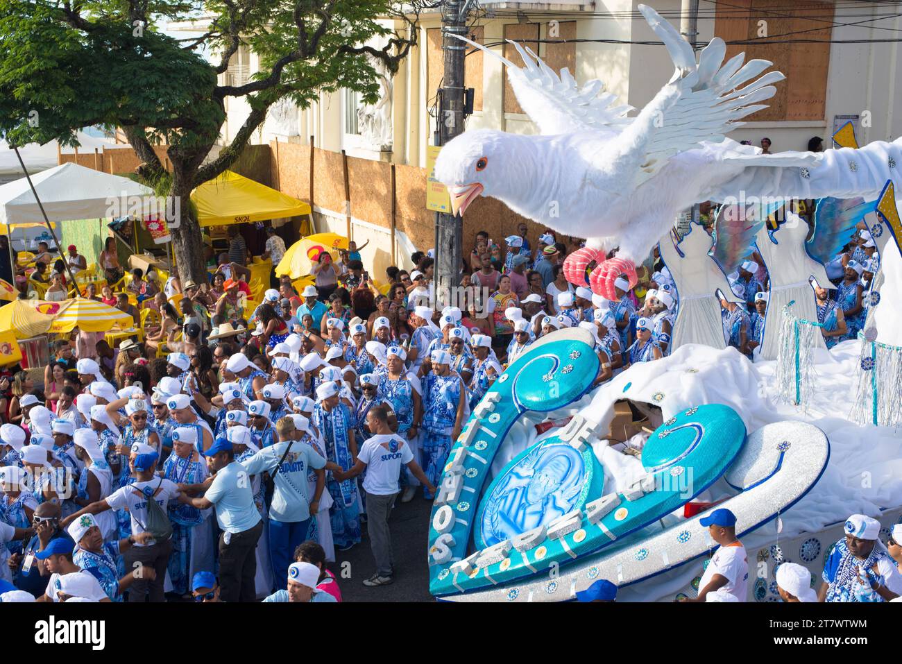 A diverse group of people of all ages enjoying a parade featuring a ...