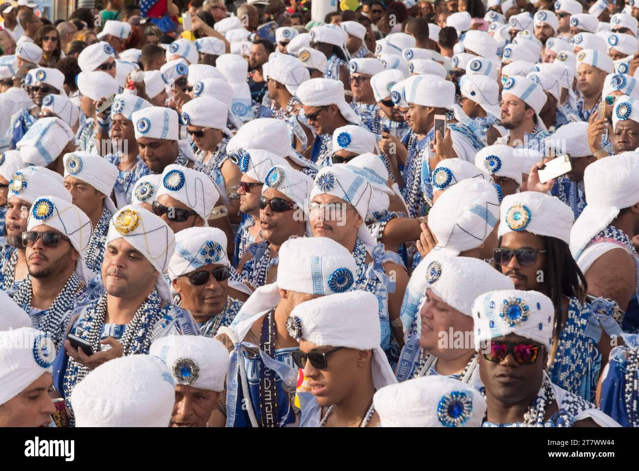 A diverse group of individuals wearing traditional clothing stand ...