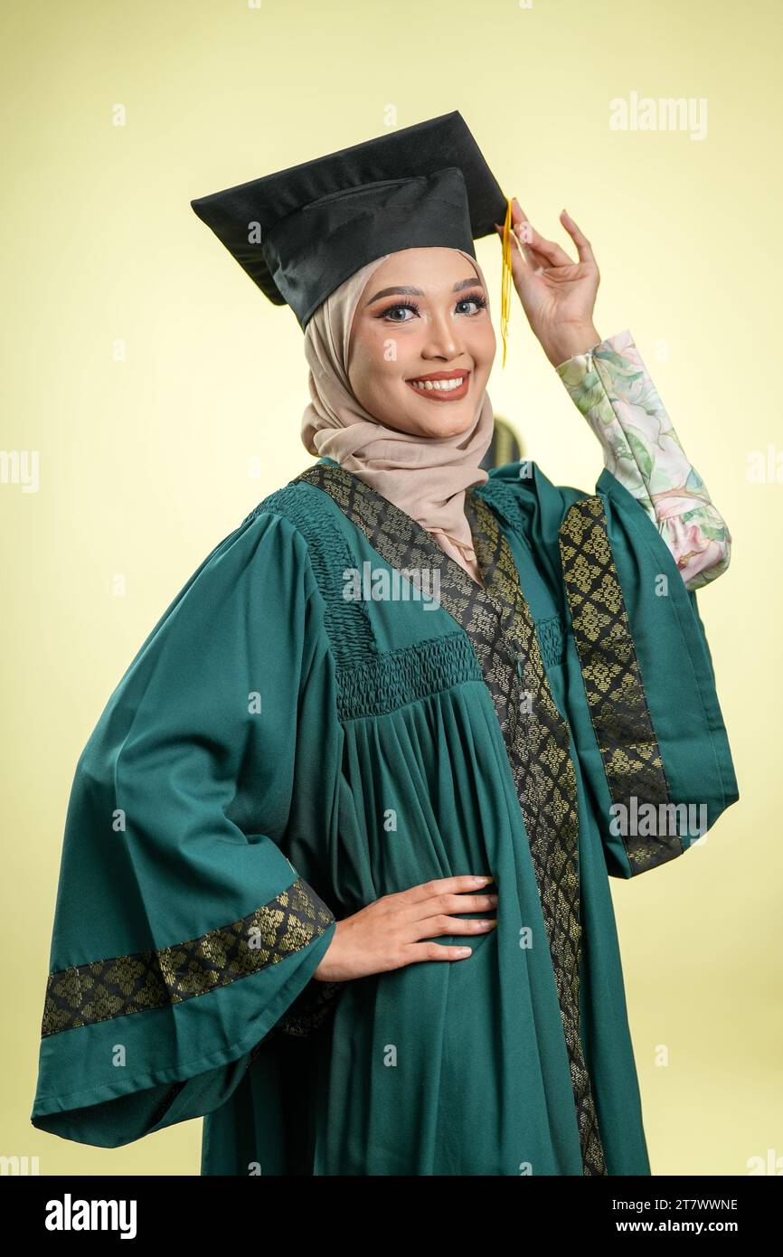 Female muslim lady posing in graduation attire Stock Photo - Alamy