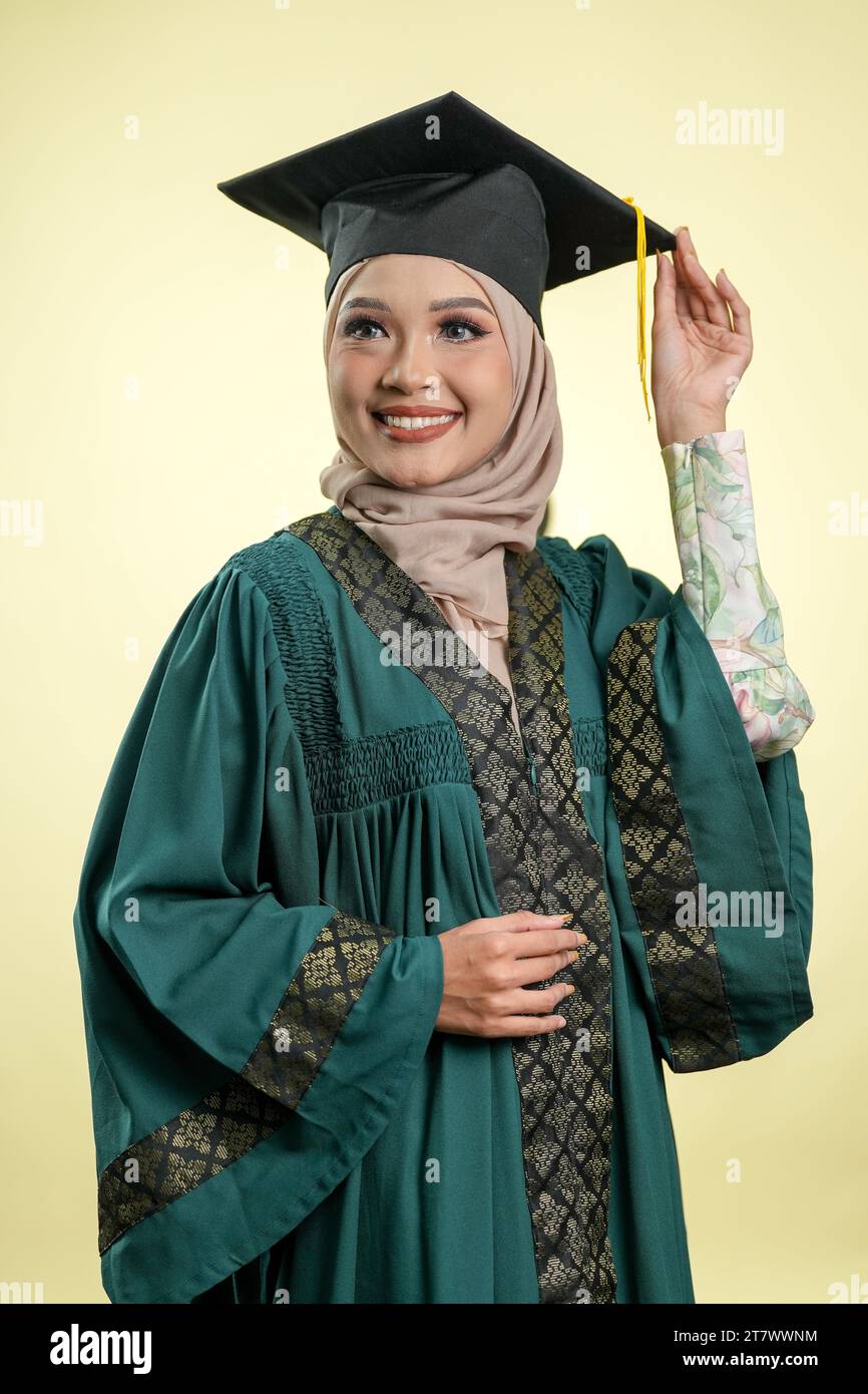 Female muslim lady posing in graduation attire Stock Photo - Alamy